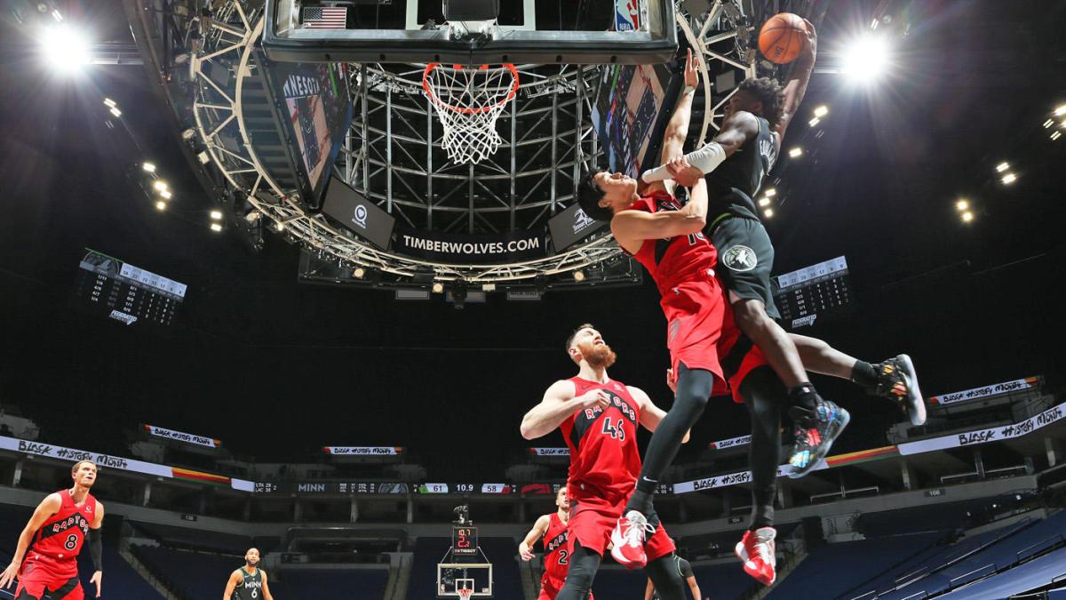 Minnesota Timberwolves guard Anthony Edwards dunks on Toronto Raptors forward Yuta Watanabe ...