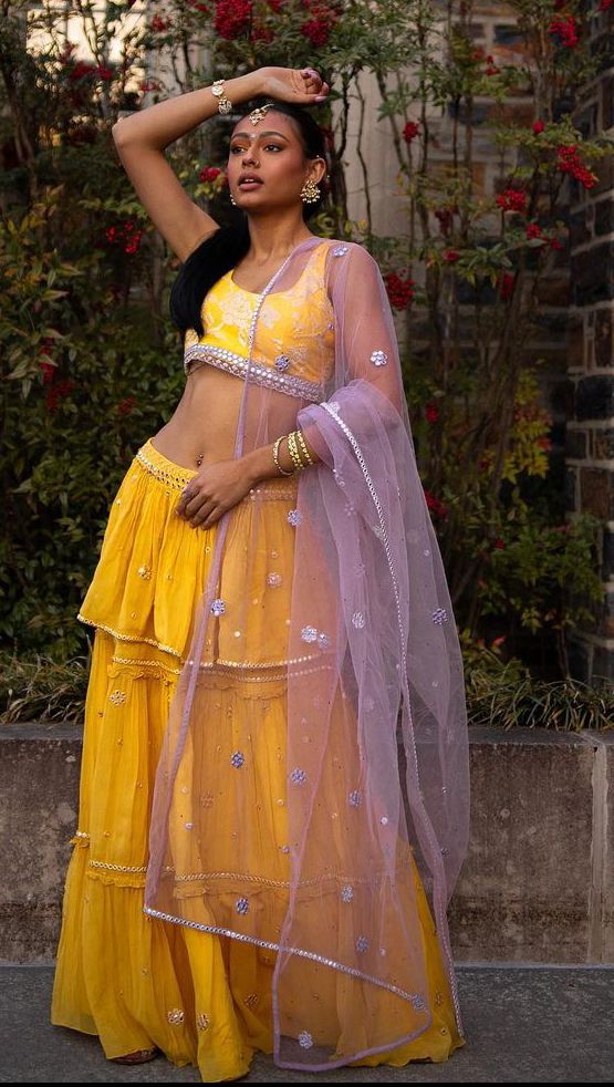 Mira Patel navel in yellow top and skirt with white stroll | Scrolller