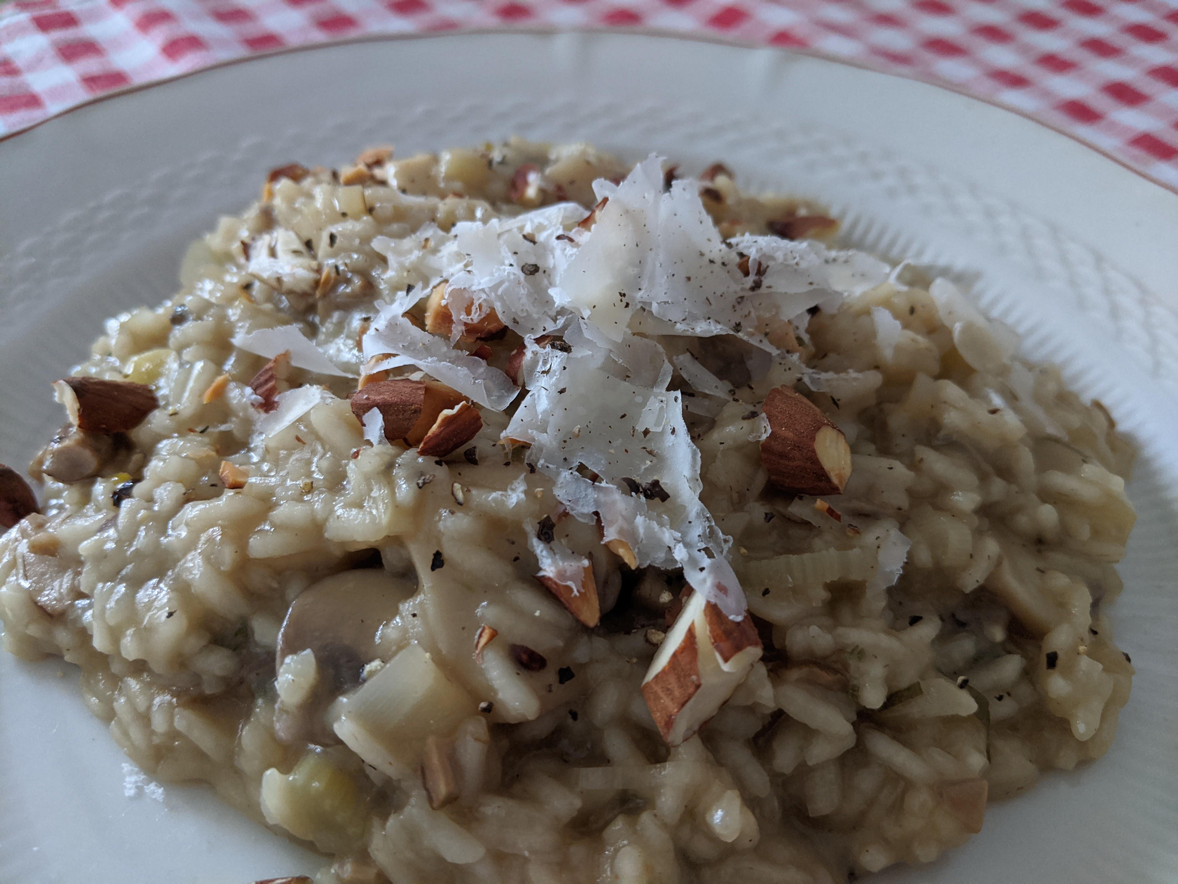 Mushroom risotto with roasted almonds and parmesan shavings on top | Scrolller