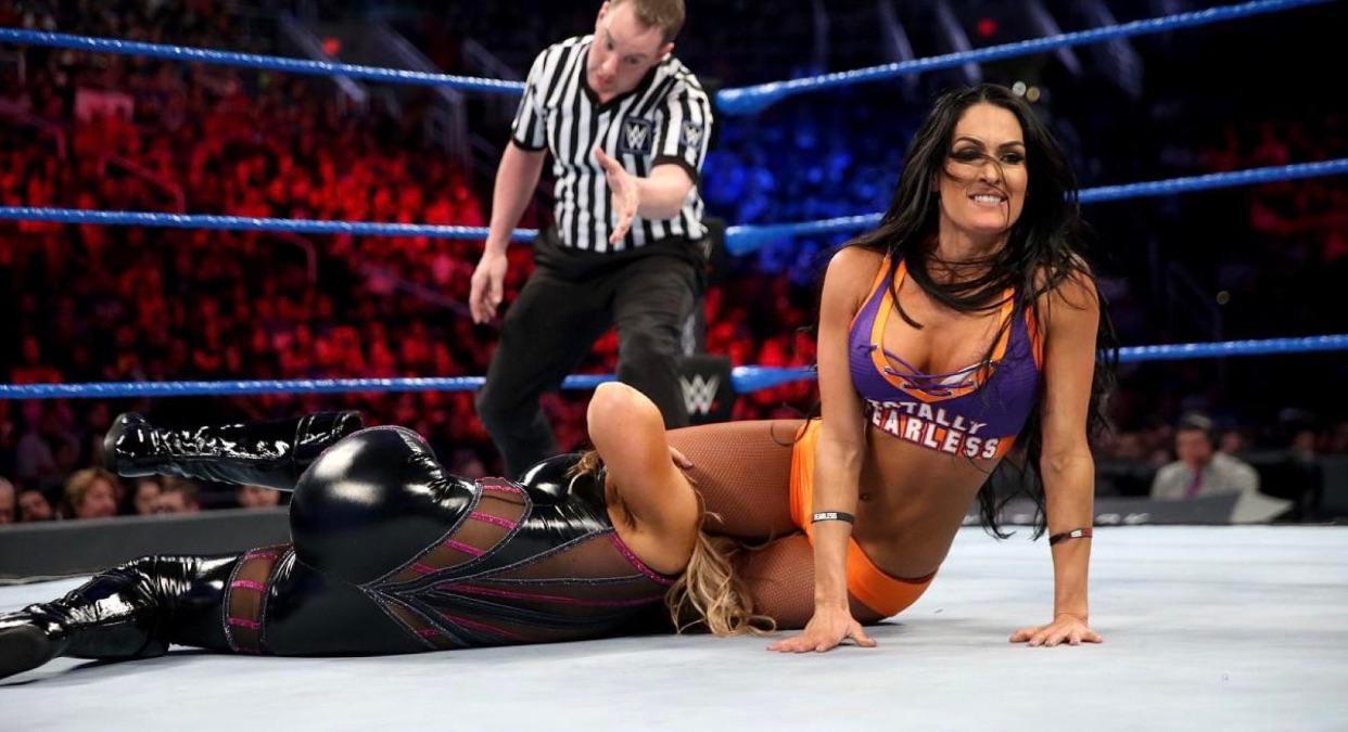 Nikki crushing Natalya’s head | Scrolller