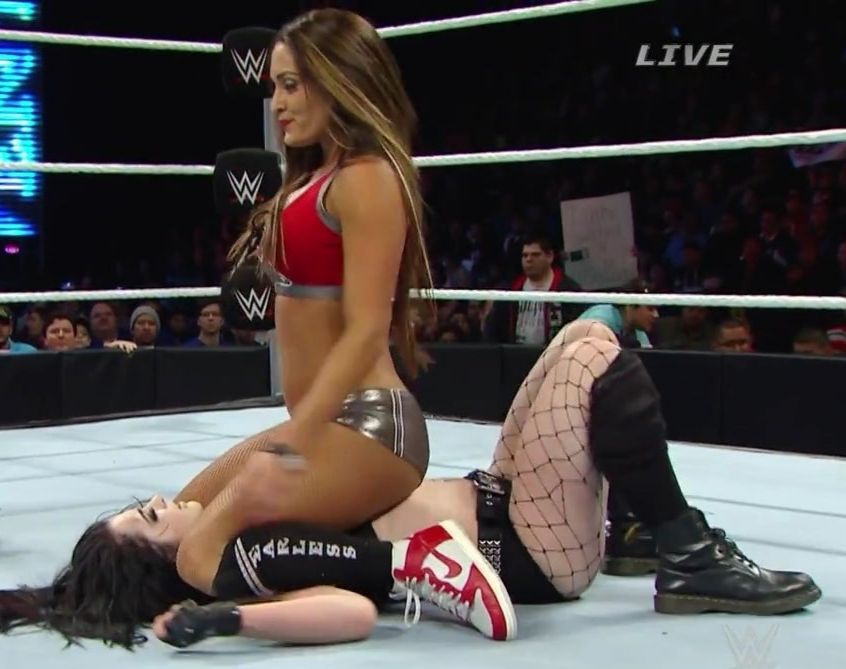 Nikki sits on Paige for the pin | Scrolller