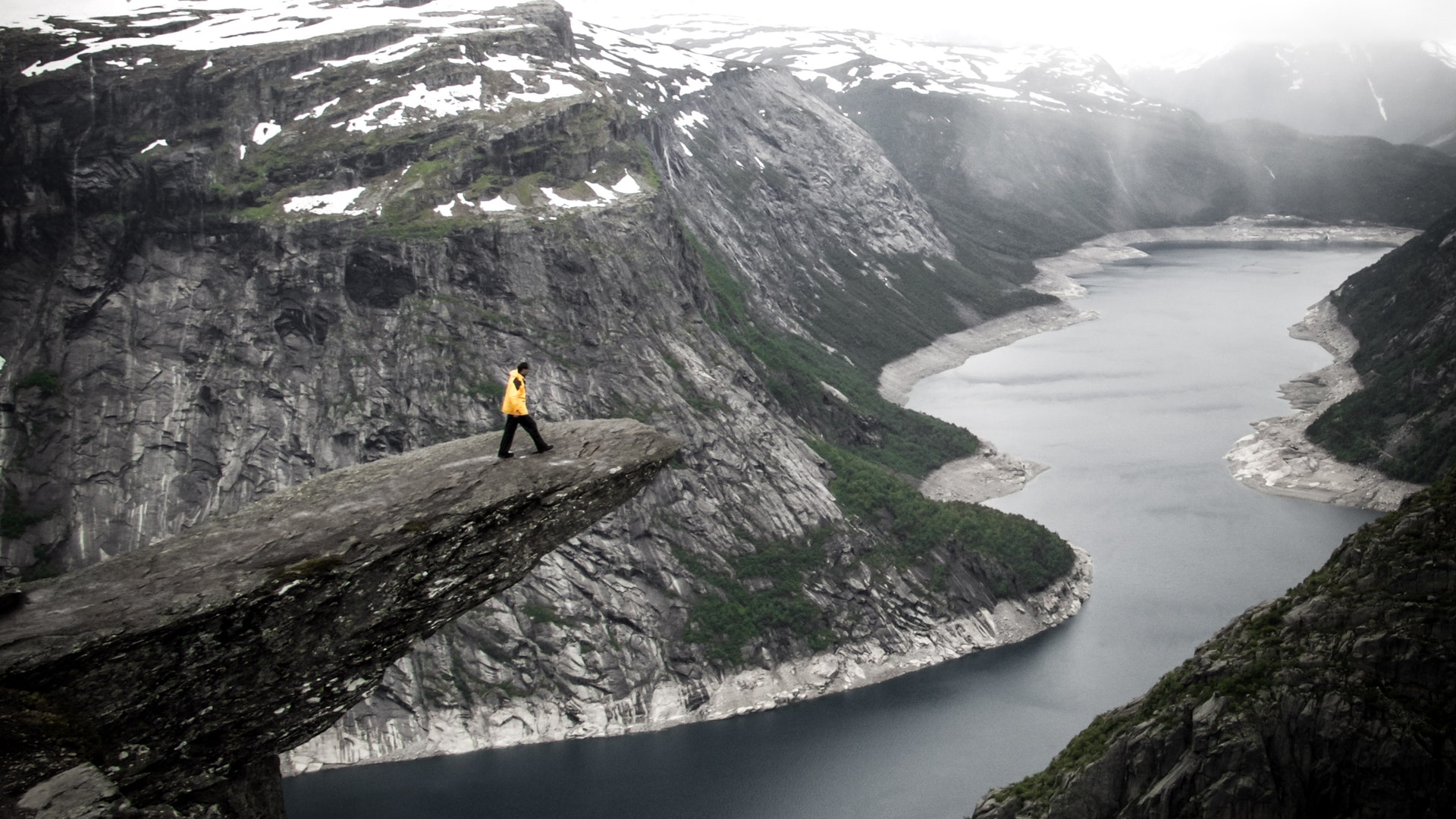 Person standing on edge of cliff | Scrolller