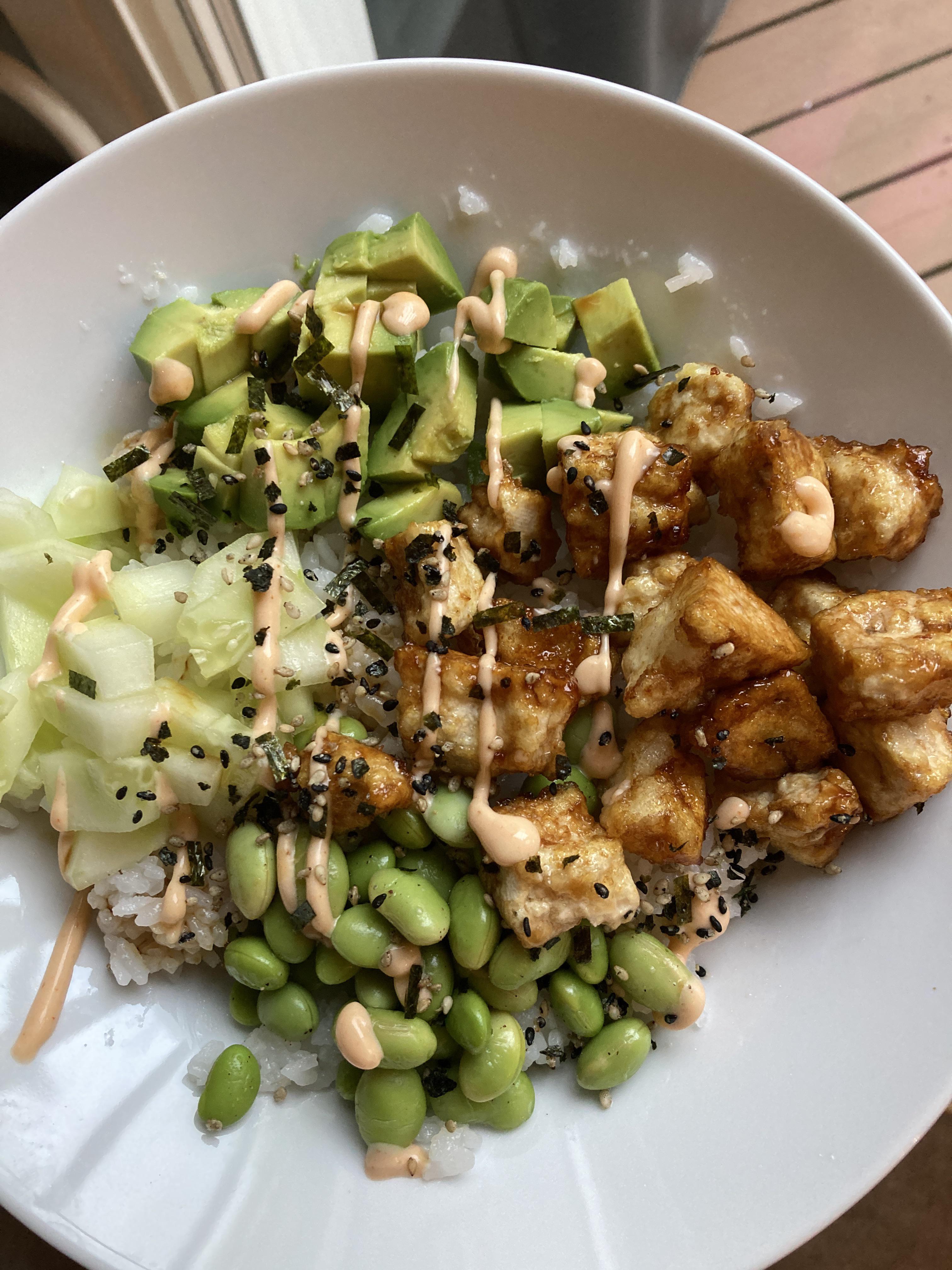 Quick sushi bowl with crispy soy sauce tofu, avocado, edamame, cucumber, rice, and spicy mayo ...