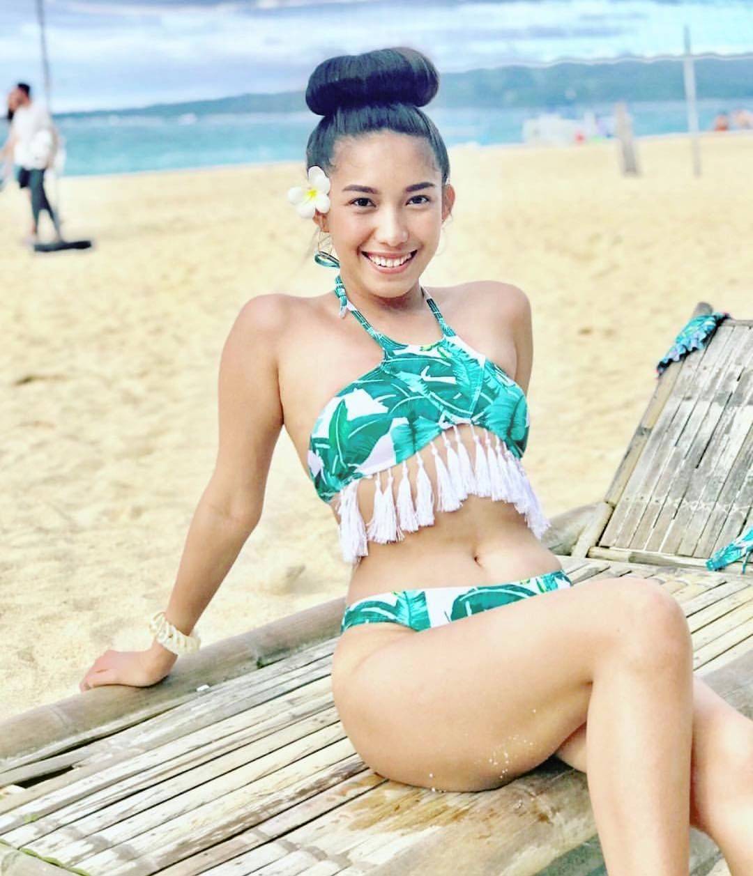Sexy Filipina smile with her hair in a bun | Scrolller