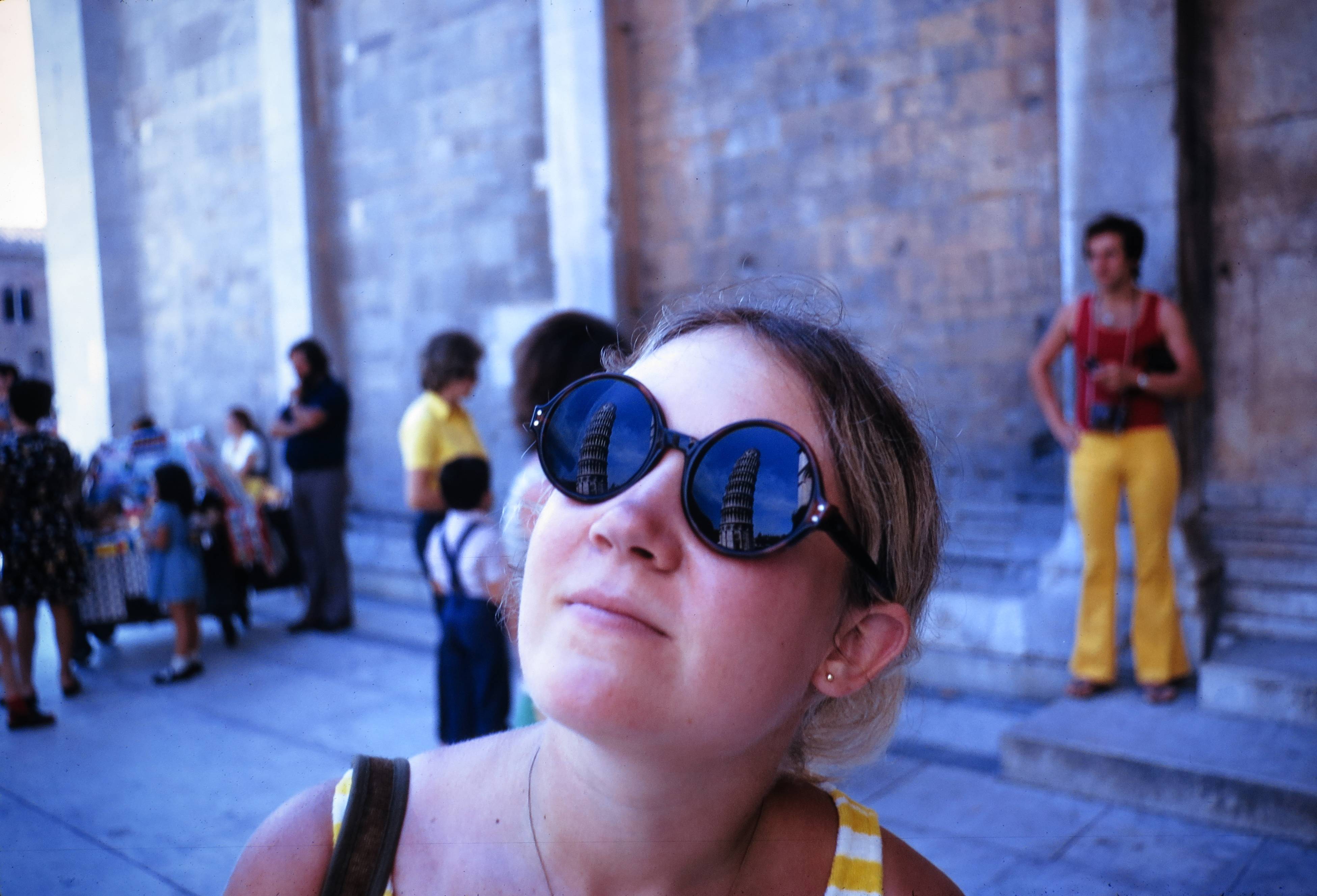 Teenage girl with a creative pose at the Leaning Tower of Pisa - August 1974 | Scrolller