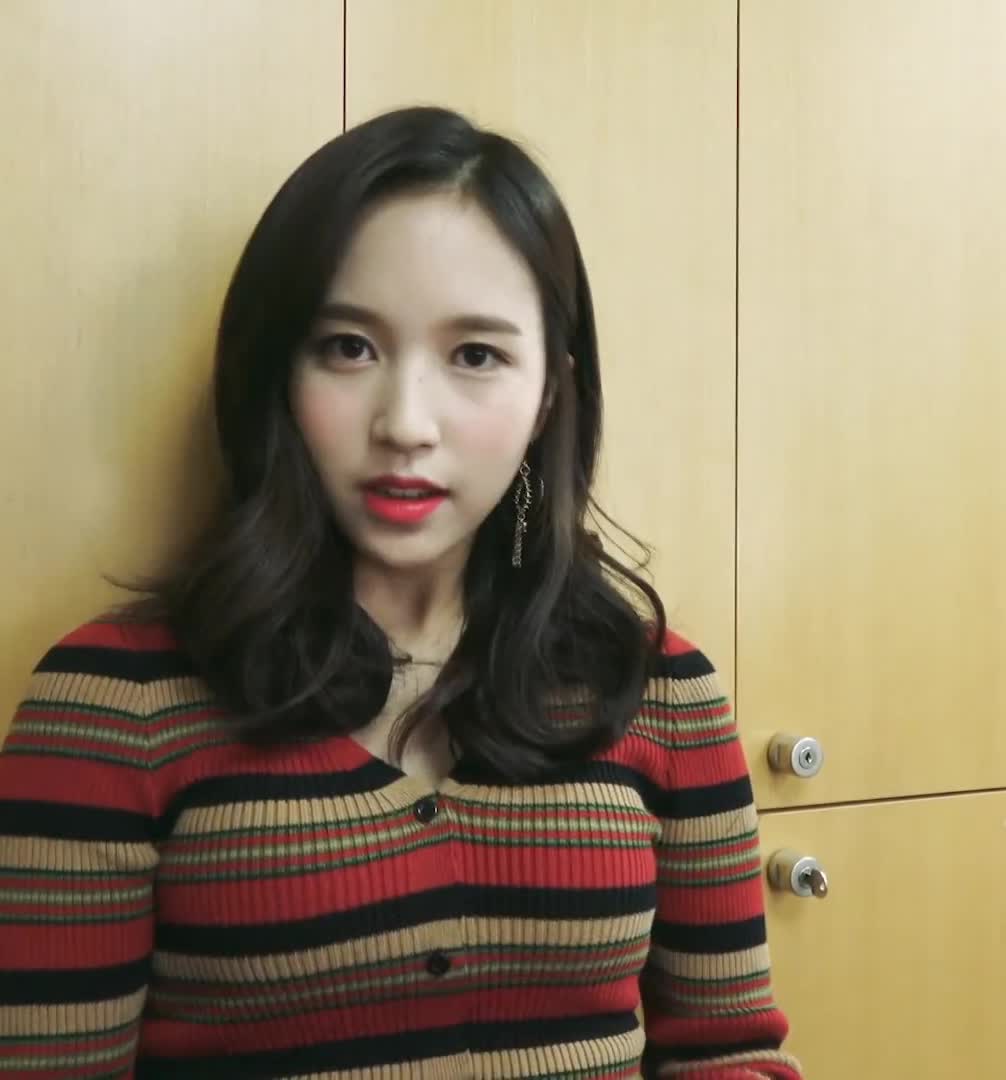 Mina - yellow, black & red sweater, close up | Scrolller