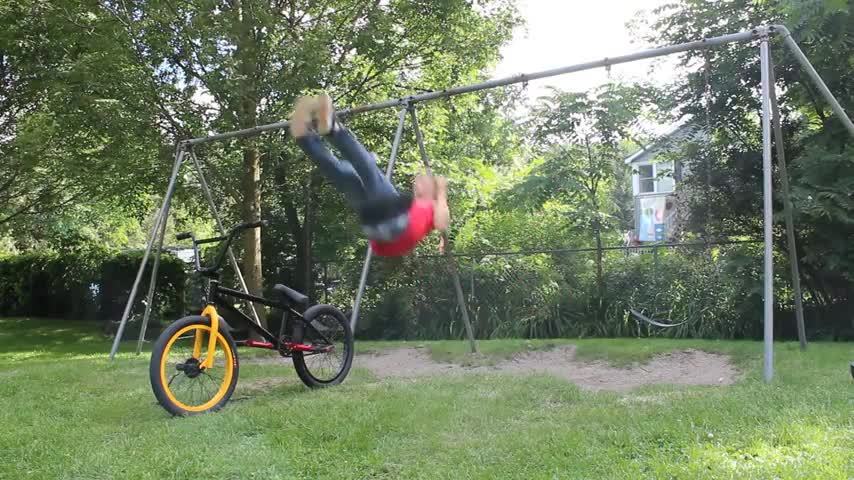 Flip from swing set onto bike | Scrolller