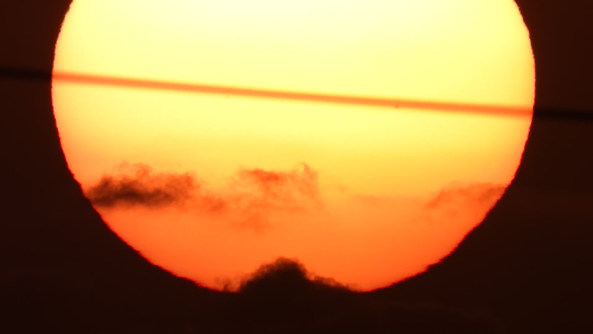 Twin engine plane flying across sunset | Scrolller