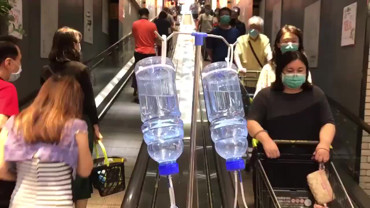 Santizing a escalator railing | Scrolller