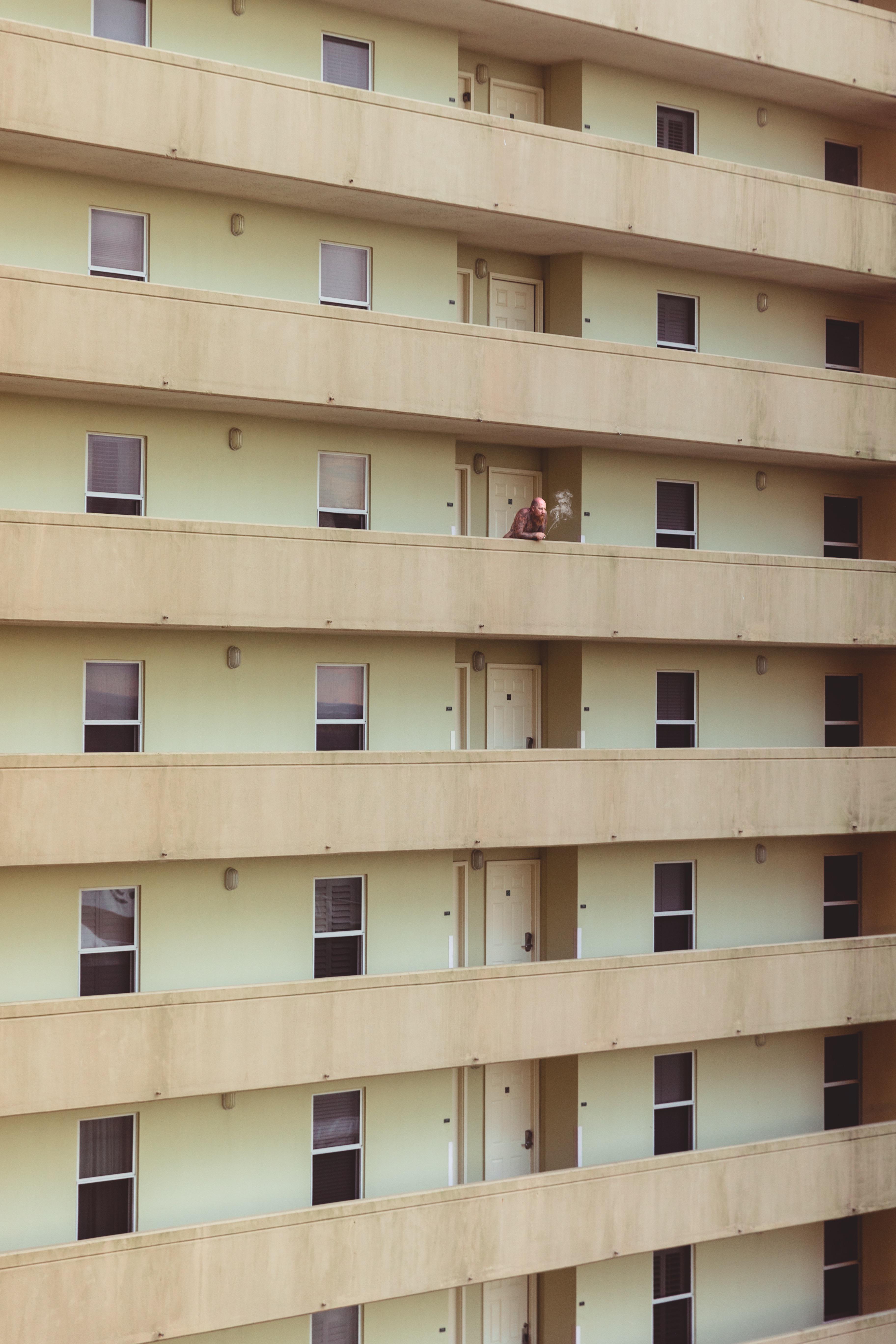 Man smoking from balcony | Scrolller