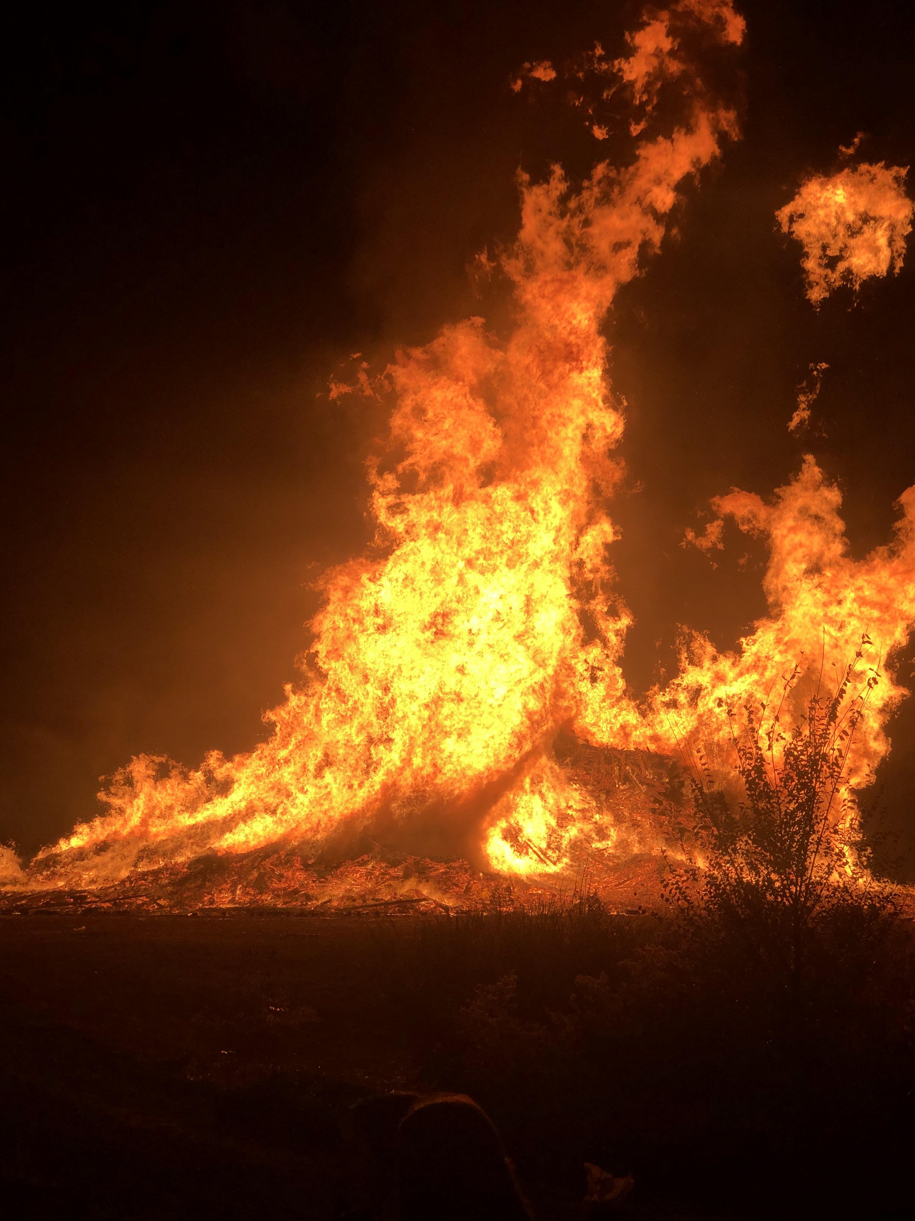 Size of Bonfire last night! 30 ft tall structure built from pallets and other wood. | Scrolller