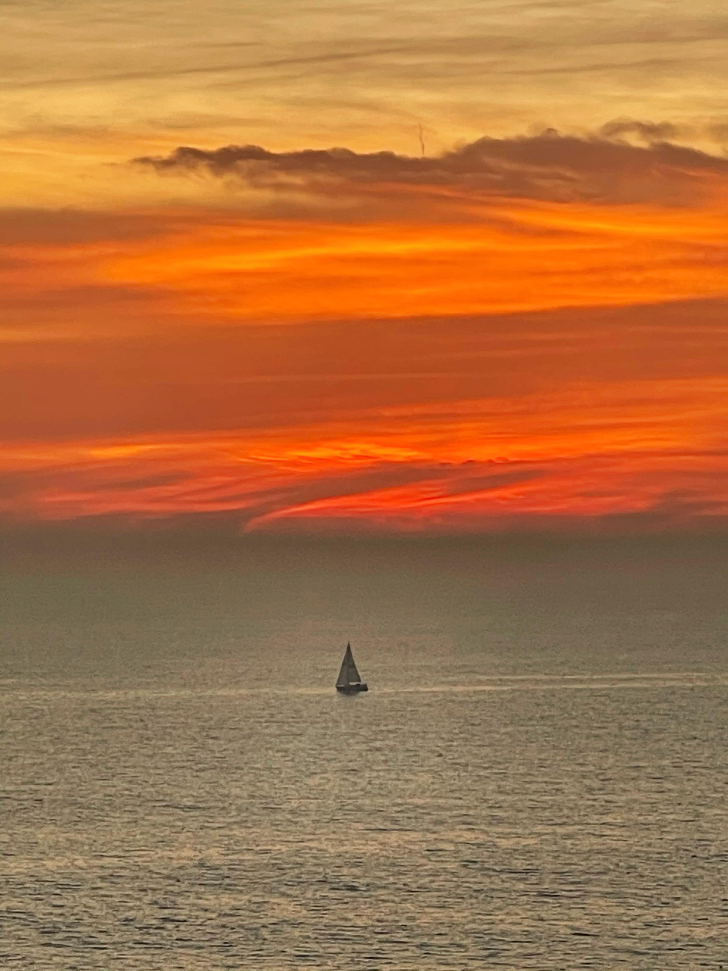 A small boat in the sunset | Scrolller