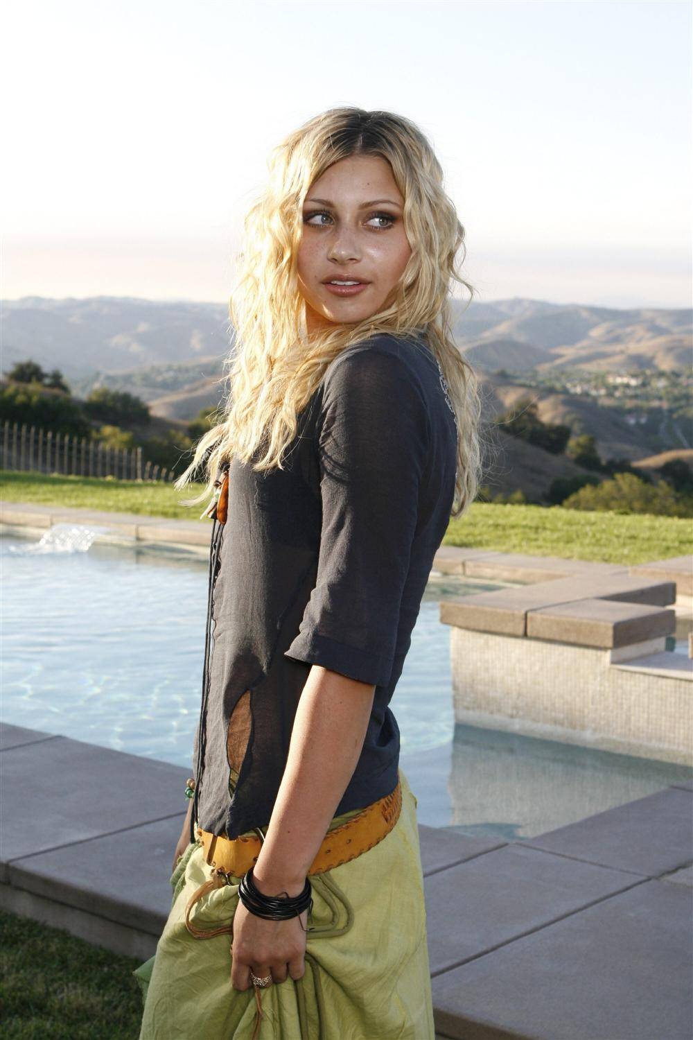 Aly Michalka posing by a pool | Scrolller