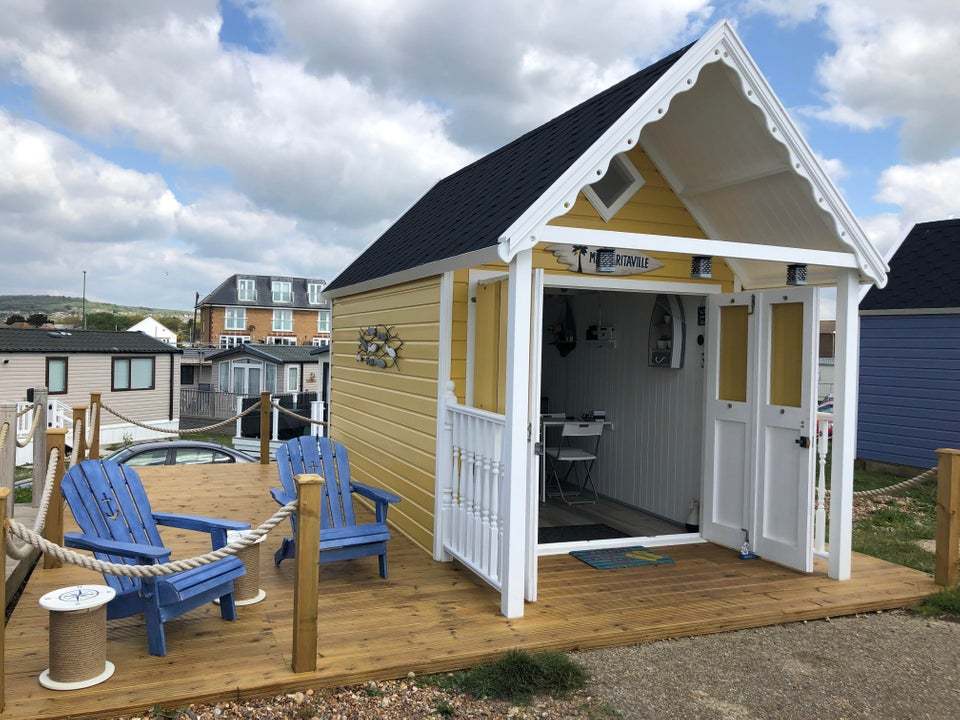 Basic beach cabin-hut with double main doors and a rope fence | Scrolller