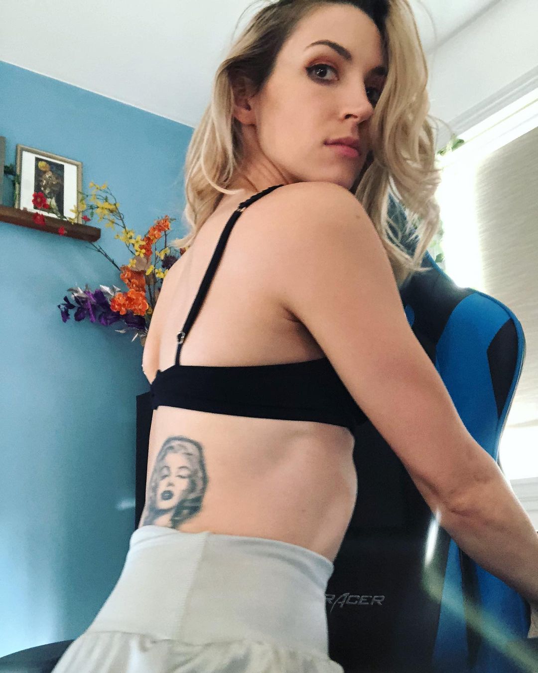 Becca Scott showing off her tattoo and back | Scrolller