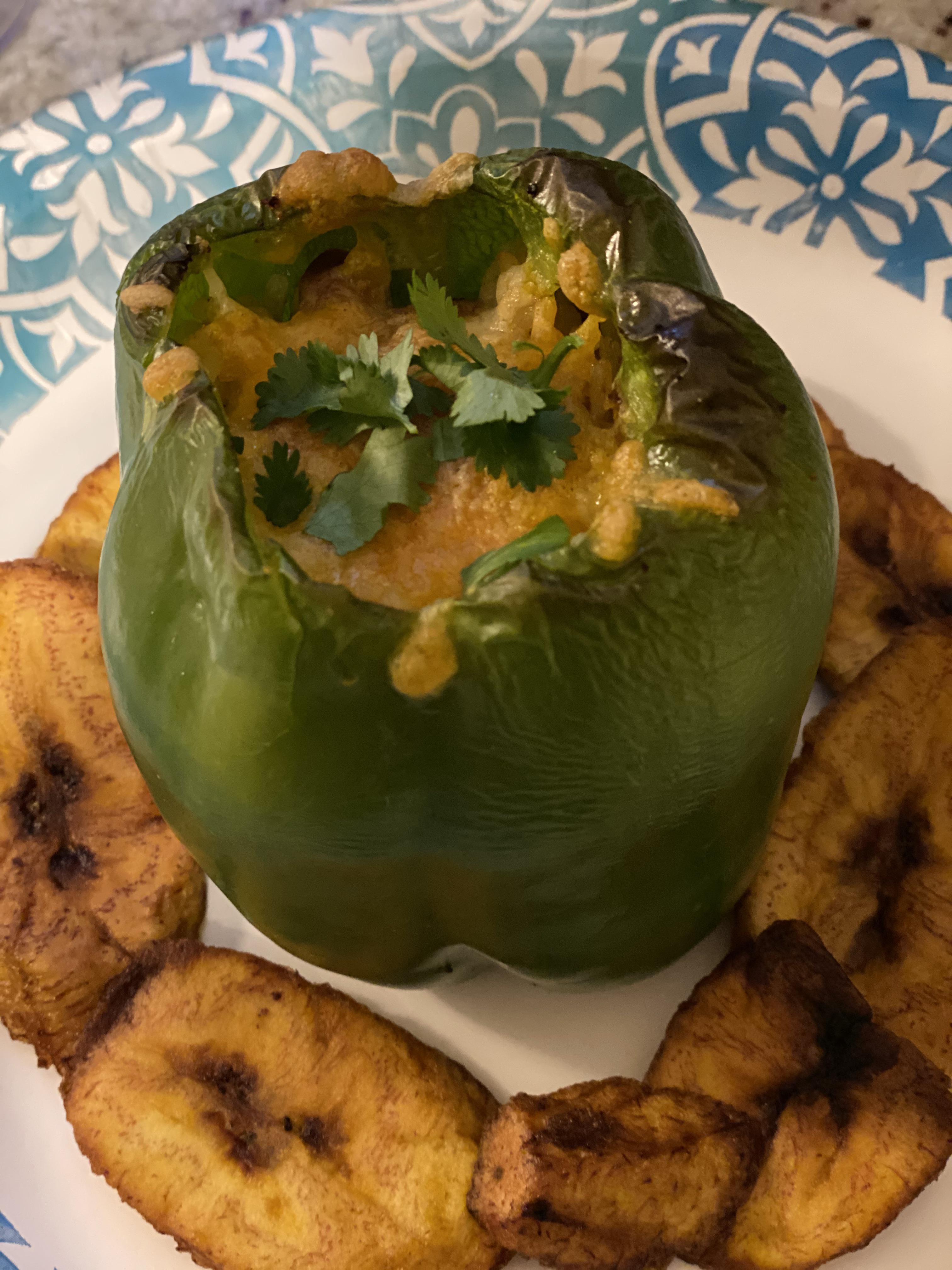 Bell pepper stuffed with Puerto Rican yellow rice, beans, plantains, cheddar cheese, and ...