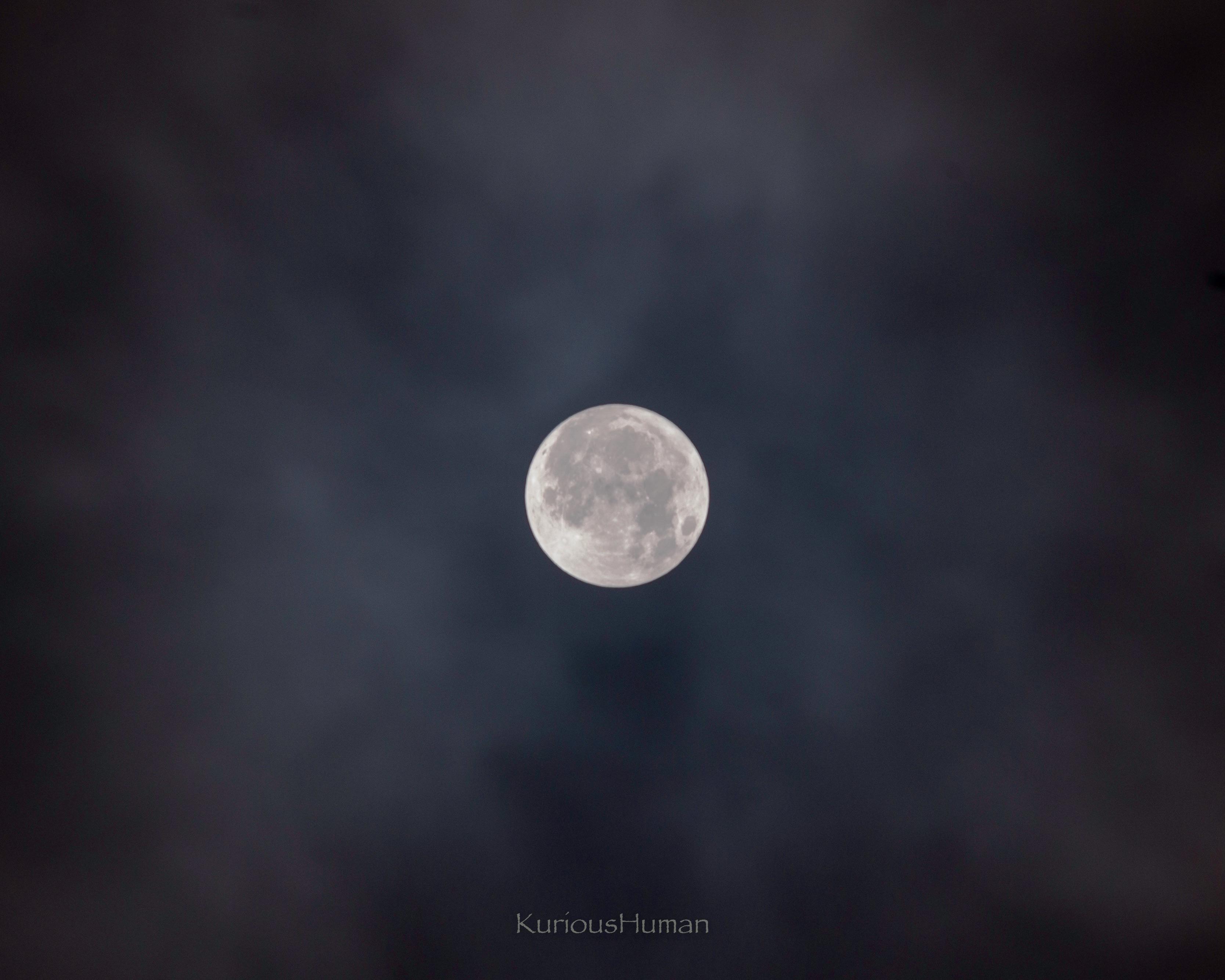 Blue Moon through a layer of clouds | Scrolller