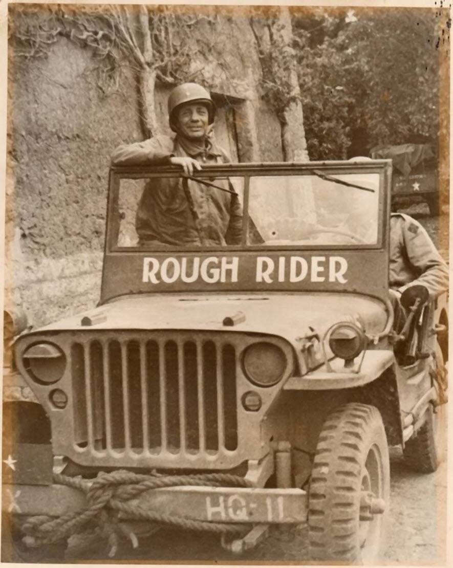 Brigadier General Theodore Roosevelt, Jr. in his Jeep 'Rough Rider' near the front lines in ...