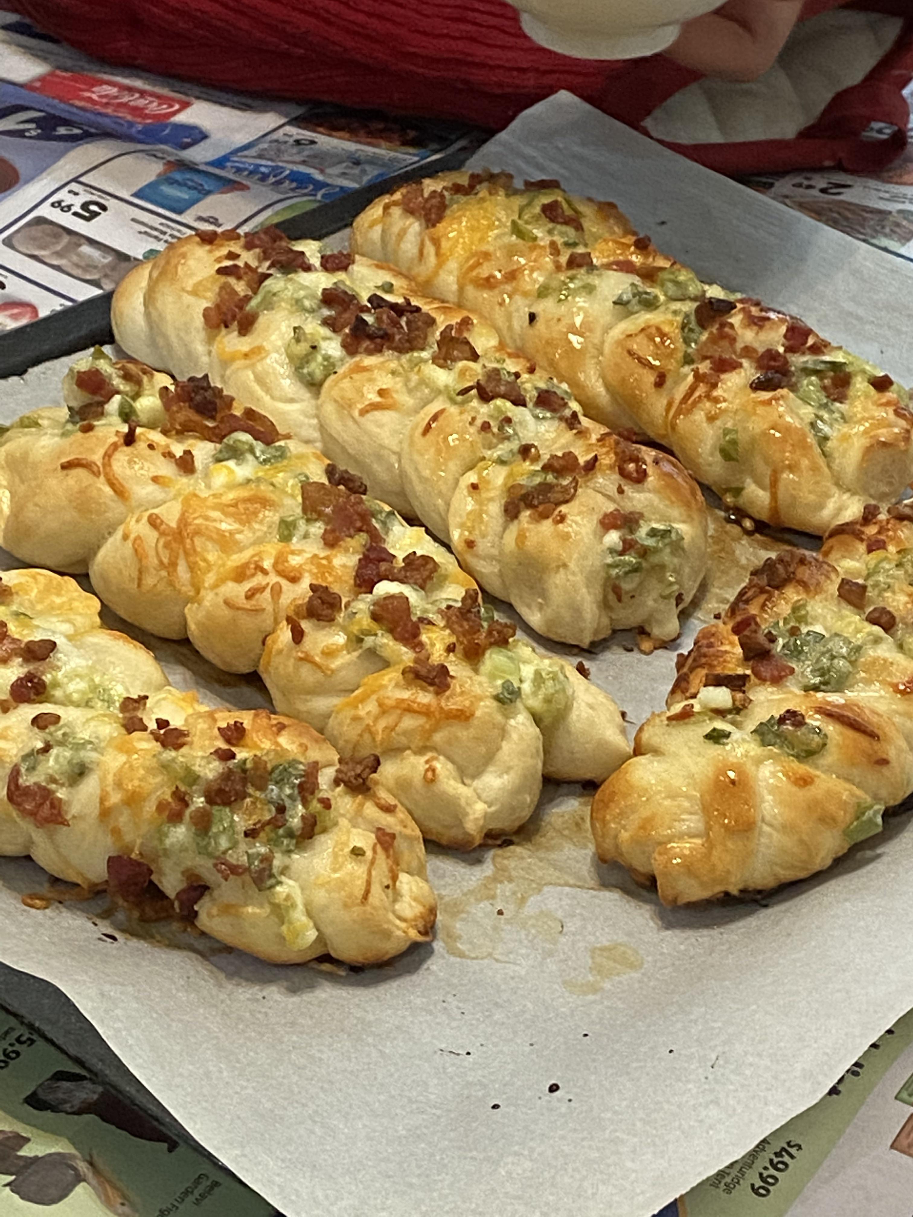 Buttery braided bread topped with custard, green onions, cheese, and bacon bits | Scrolller