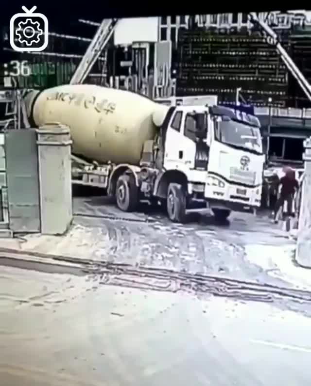 Cement mixing truck topples over the ledge of a construction site | Scrolller