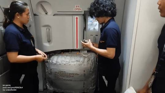 Deploying plane evacuation slide from passenger POV | Scrolller