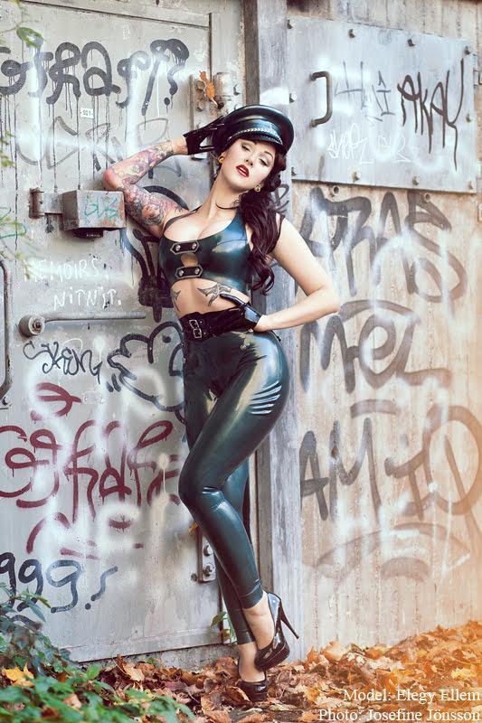 Elegy Ellem in a military style latex outfit. | Scrolller