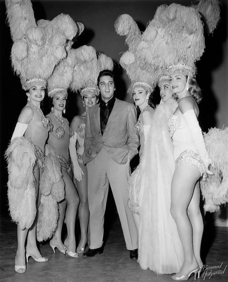 Elvis surrounded by Las Vegas showgirls | Scrolller