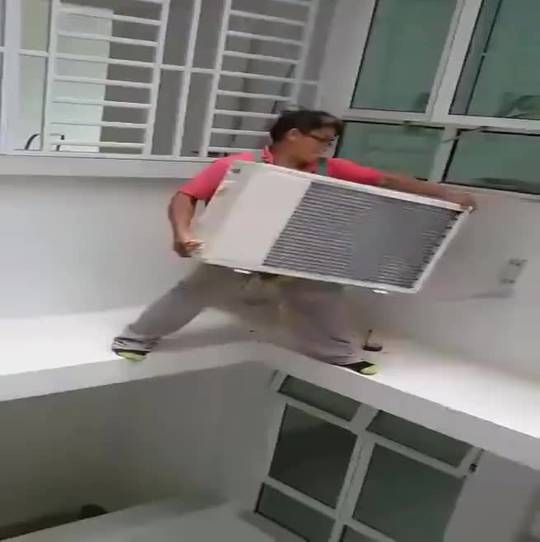 Fitting an airconditioner - some 45 bazillion levels above the ground | Scrolller