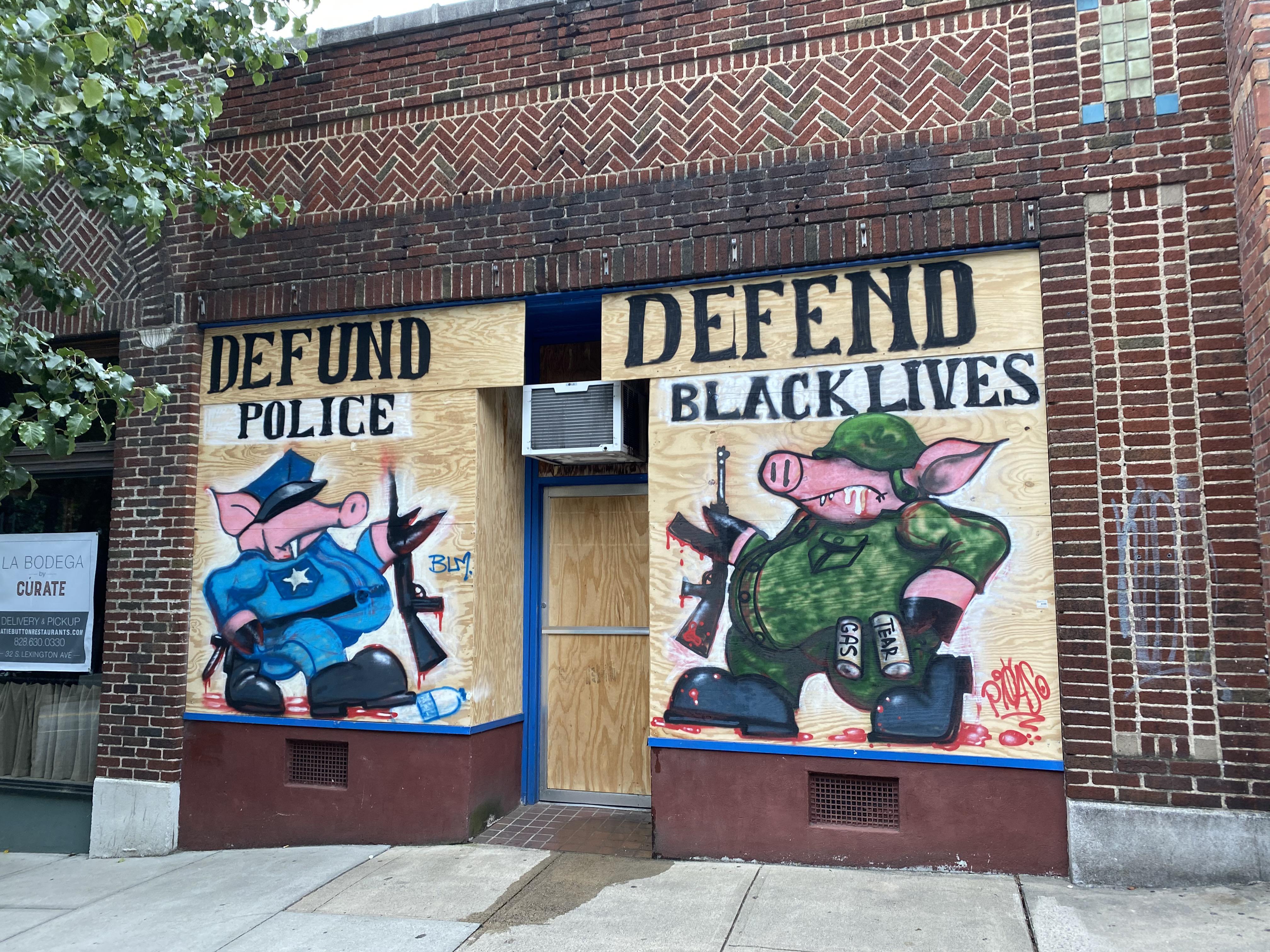 Freshly painted on a boarded up downtown business. Asheville, NC | Scrolller