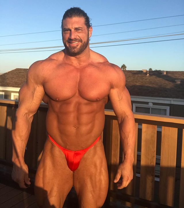Gabe Moen in red posing trunks | Scrolller