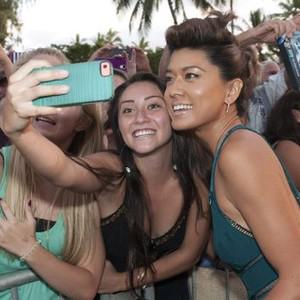 Grace taking a photos with a fan | Scrolller