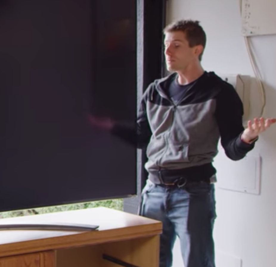 His left arm was perfectly aligned with the reflection of his right arm making the TV look ...