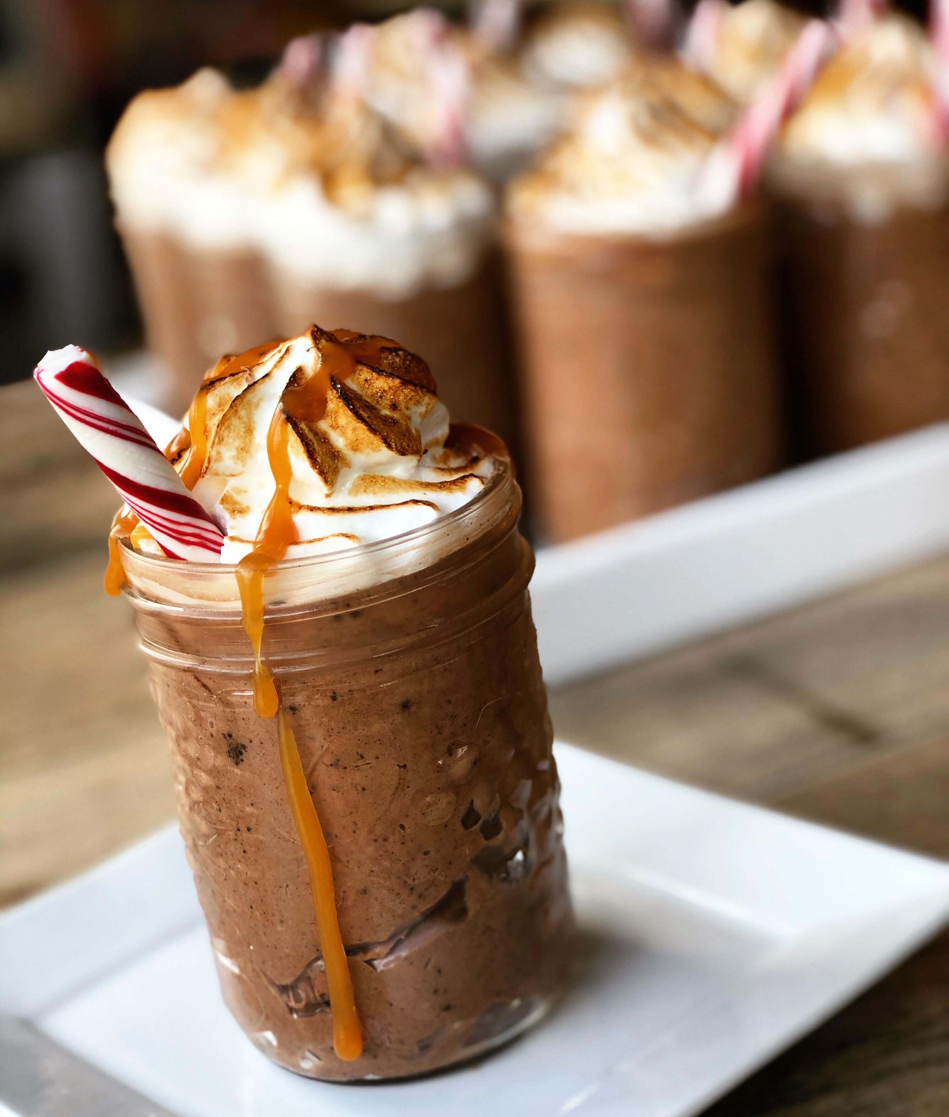 Hot chocolate cheesecake, topped with torched meringue, peppermint straw and salted caramel ...