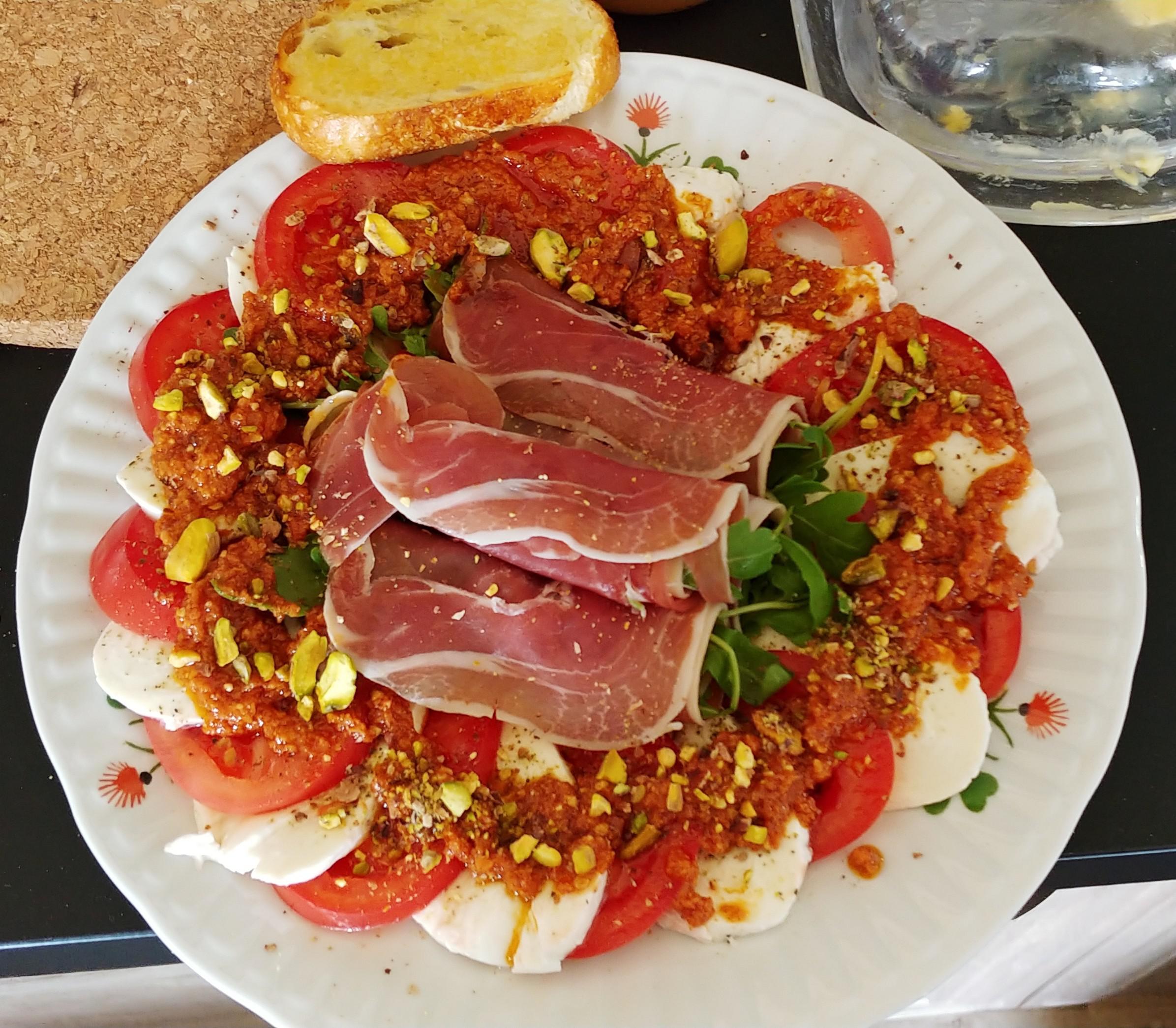 Italian salad my girlfriend made me for breakfast with tomatoes, green pesto, mozzarella ...