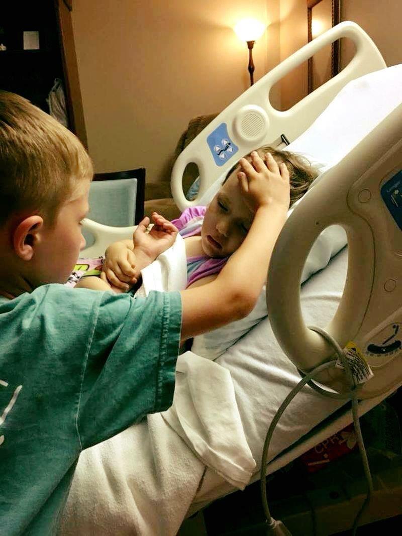 Kid stands by his sisters bedside moments before her passing. DIPG is horribly depressing ...