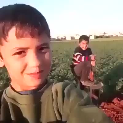 Kids playing with an AK-47 | Scrolller