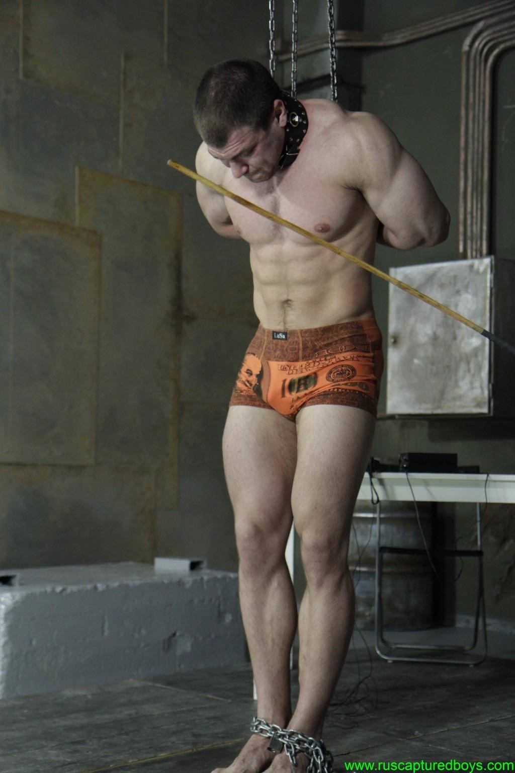 Muscular Prisoner prepared for chest caning. A pic from RusCapturedBoys.com video “The First ...