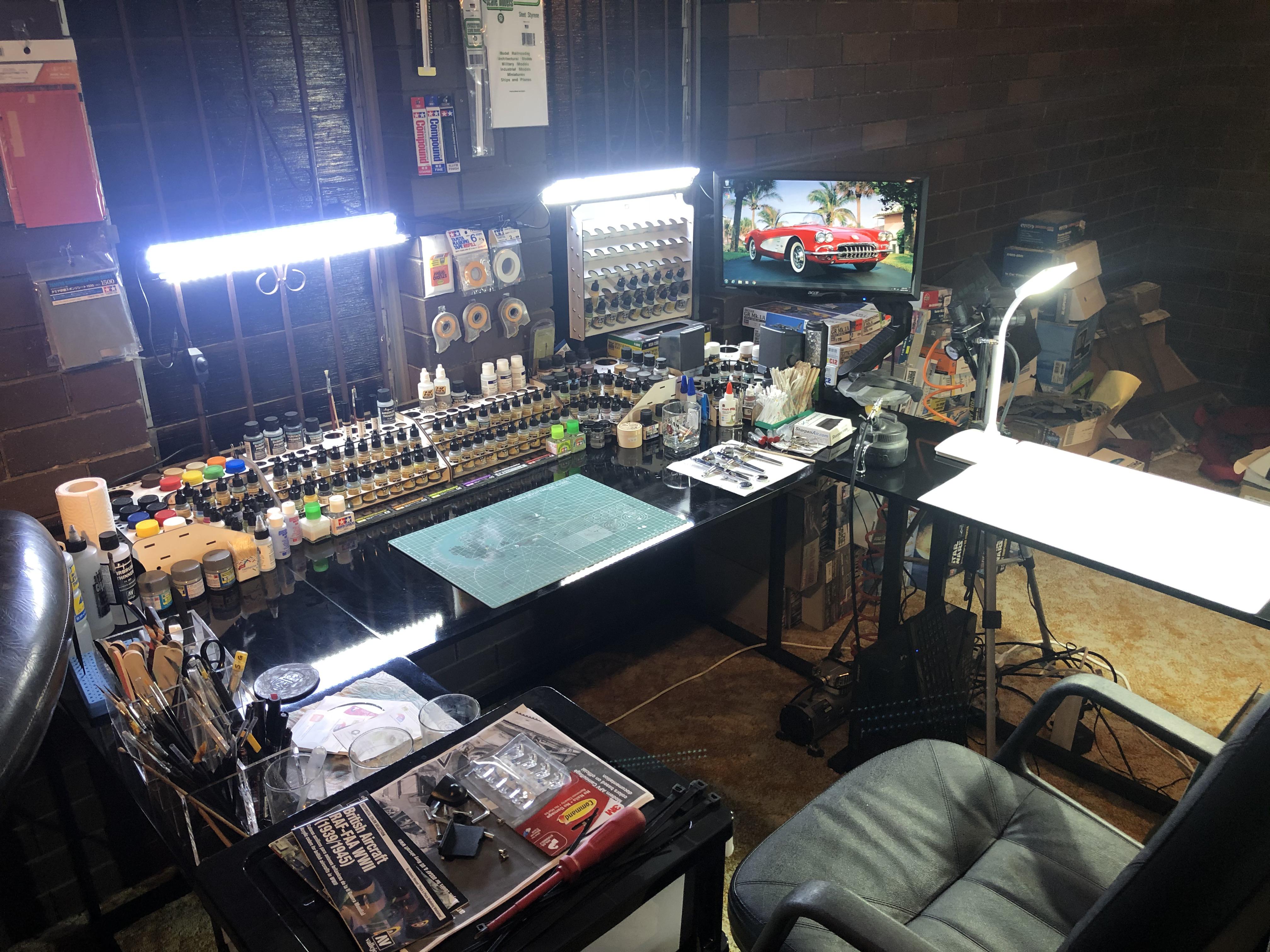 My ever evolving workbench . You can never have too much light or too many paint colours 😳 ...