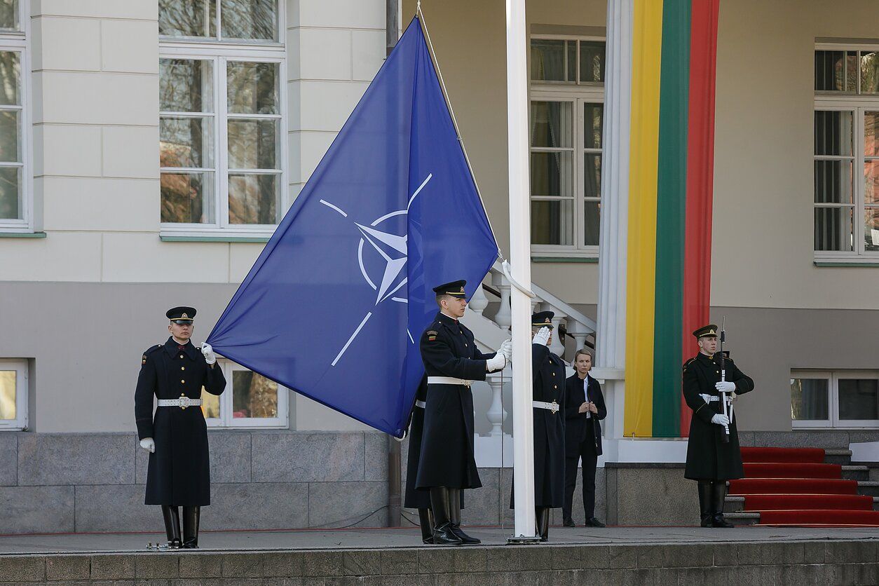 NATO flag and Lithuanian soldiers | Scrolller
