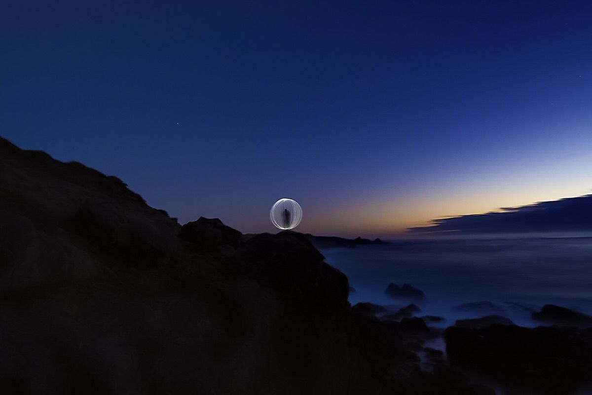 Orb on a cliff above the ocean | Scrolller