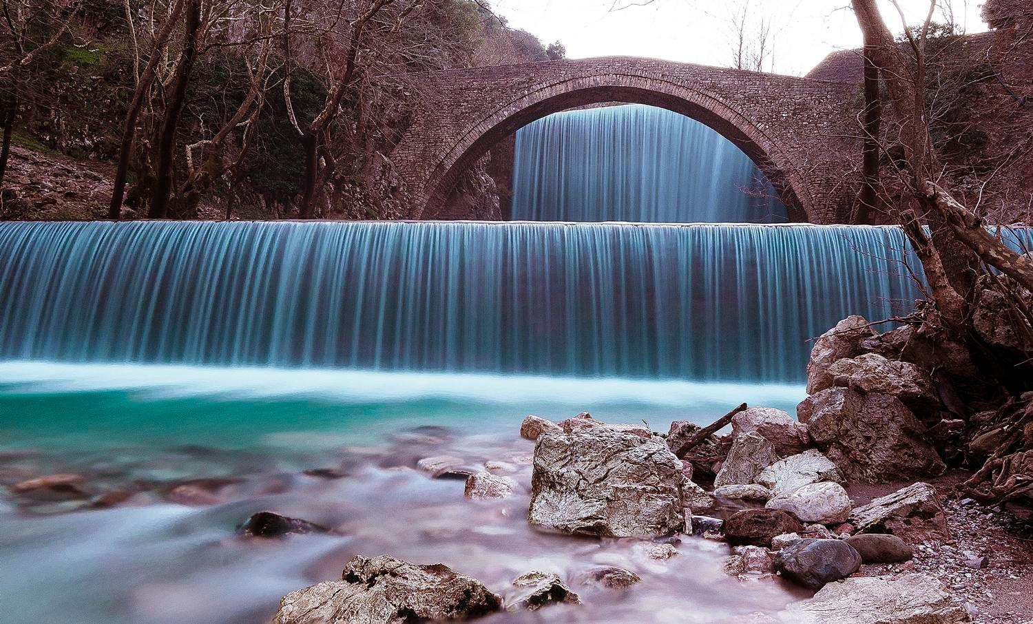 Palaiokaria's stone bridge, between two waterfalls at Trikala Greece | Scrolller