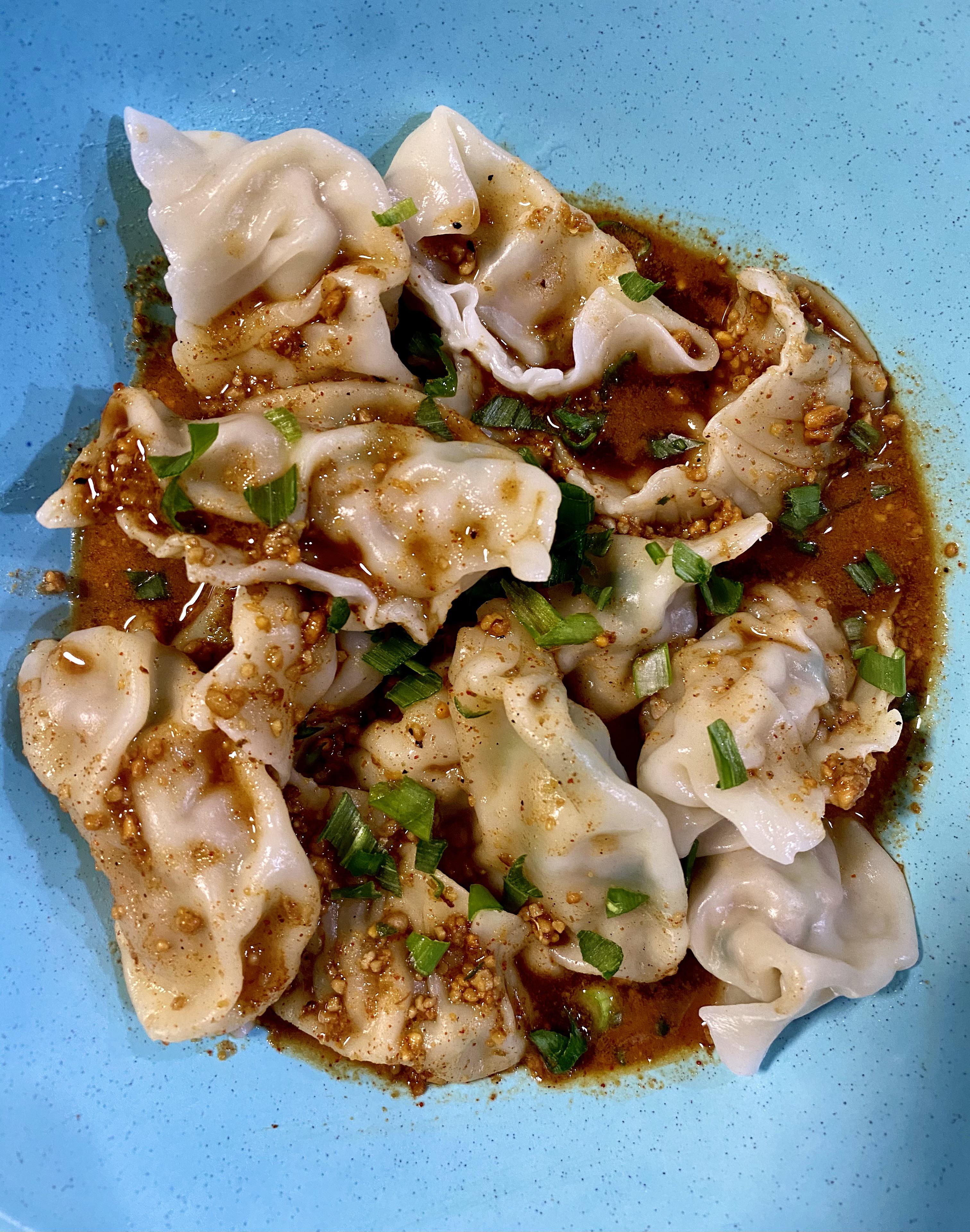 Pork and cabbage dumplings in a Szechuan peppercorn sauce. | Scrolller