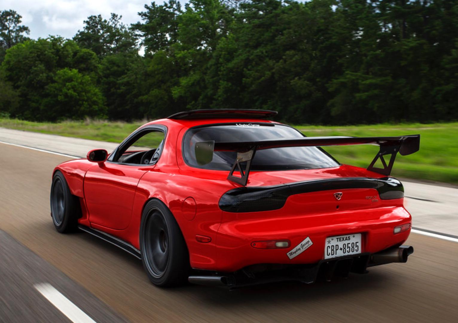 Red Mazda RX7 on a Texas road | Scrolller
