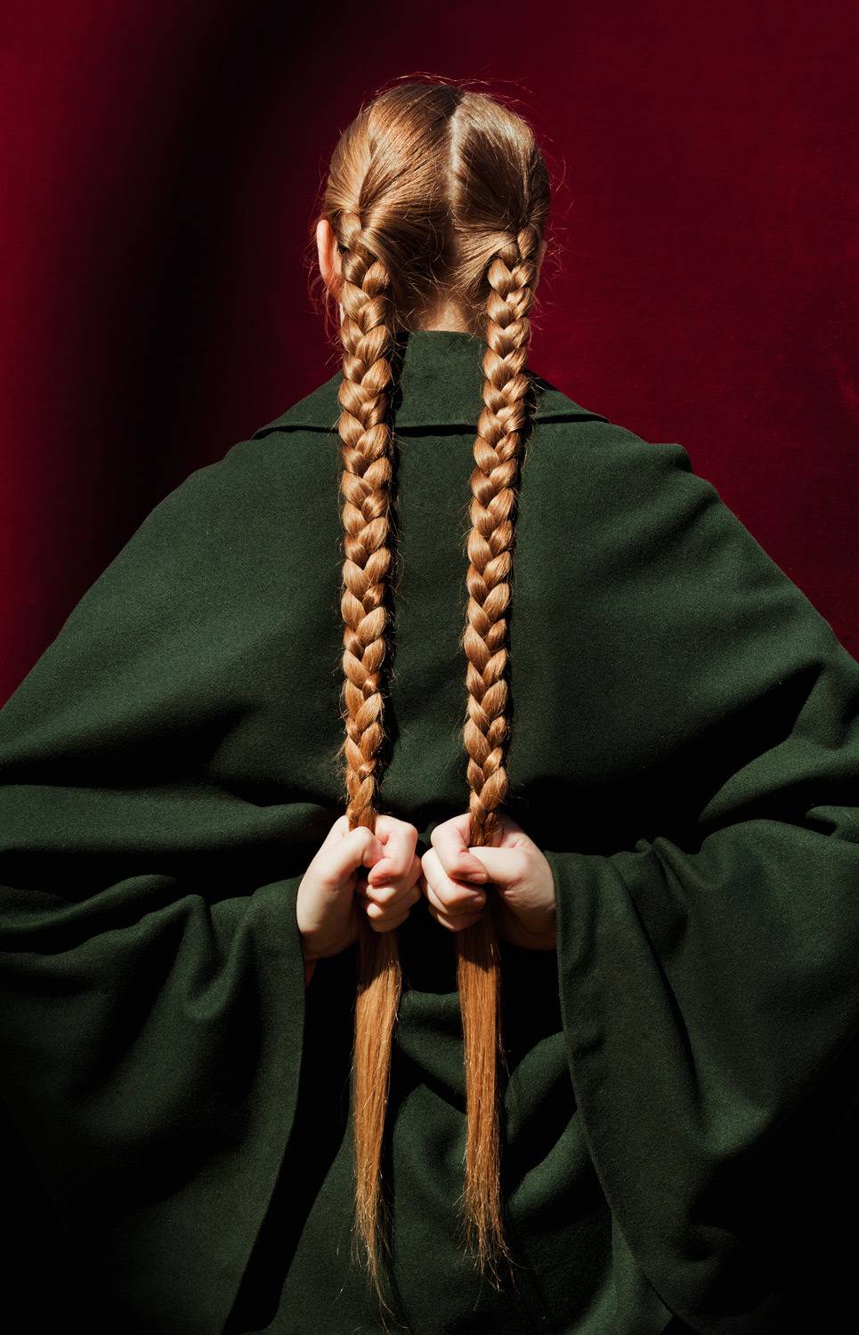 Redhead holding her braids | Scrolller