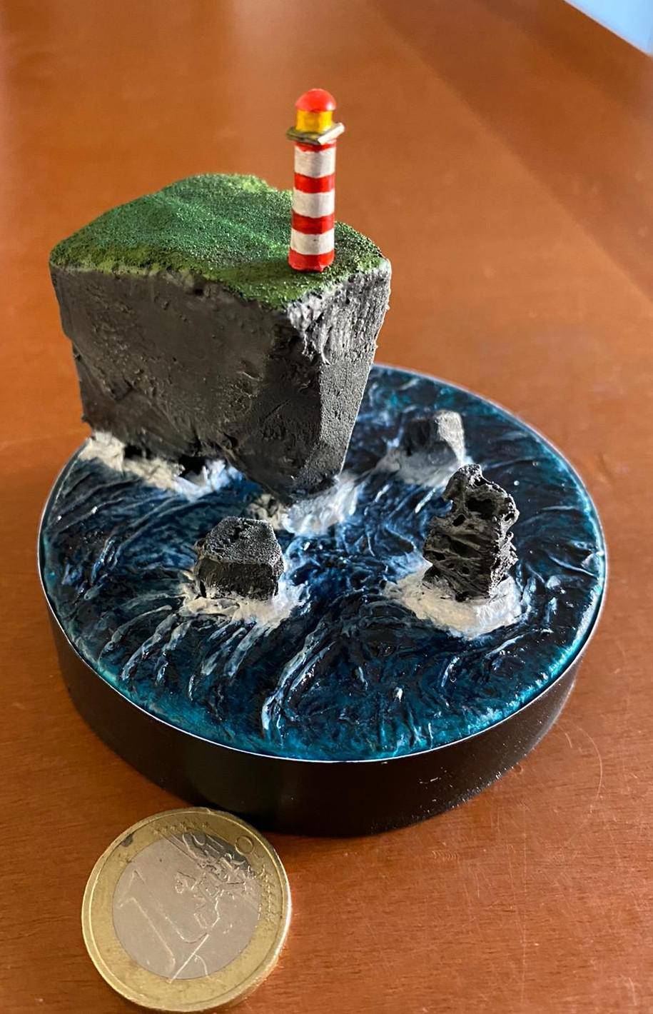 Scratch built small diorama of a lighthouse on the top of a cliff. I made it for my better half ...