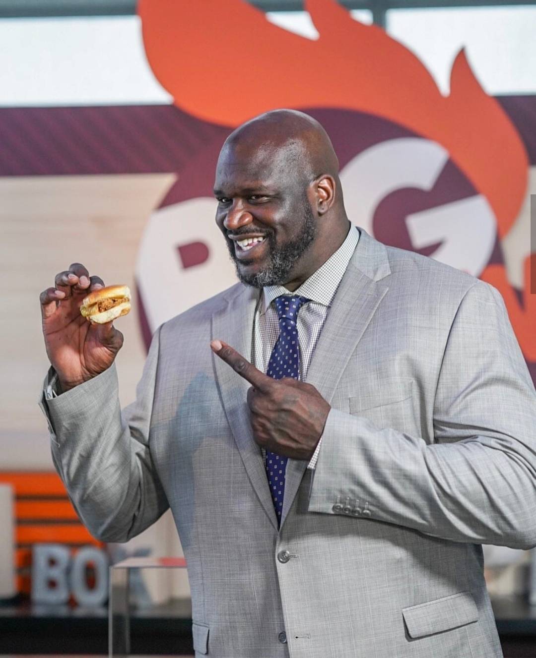 Shaq holding his big chicken shaq sandwich | Scrolller