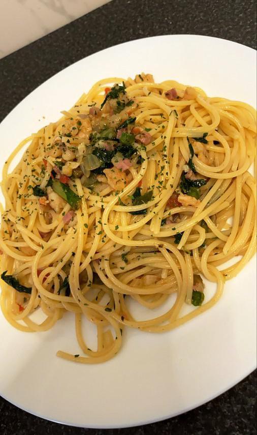 Spicy Sausage, caramelized Onions and asparagus, in a pan sauce on a fresh spaghetti. | Scrolller