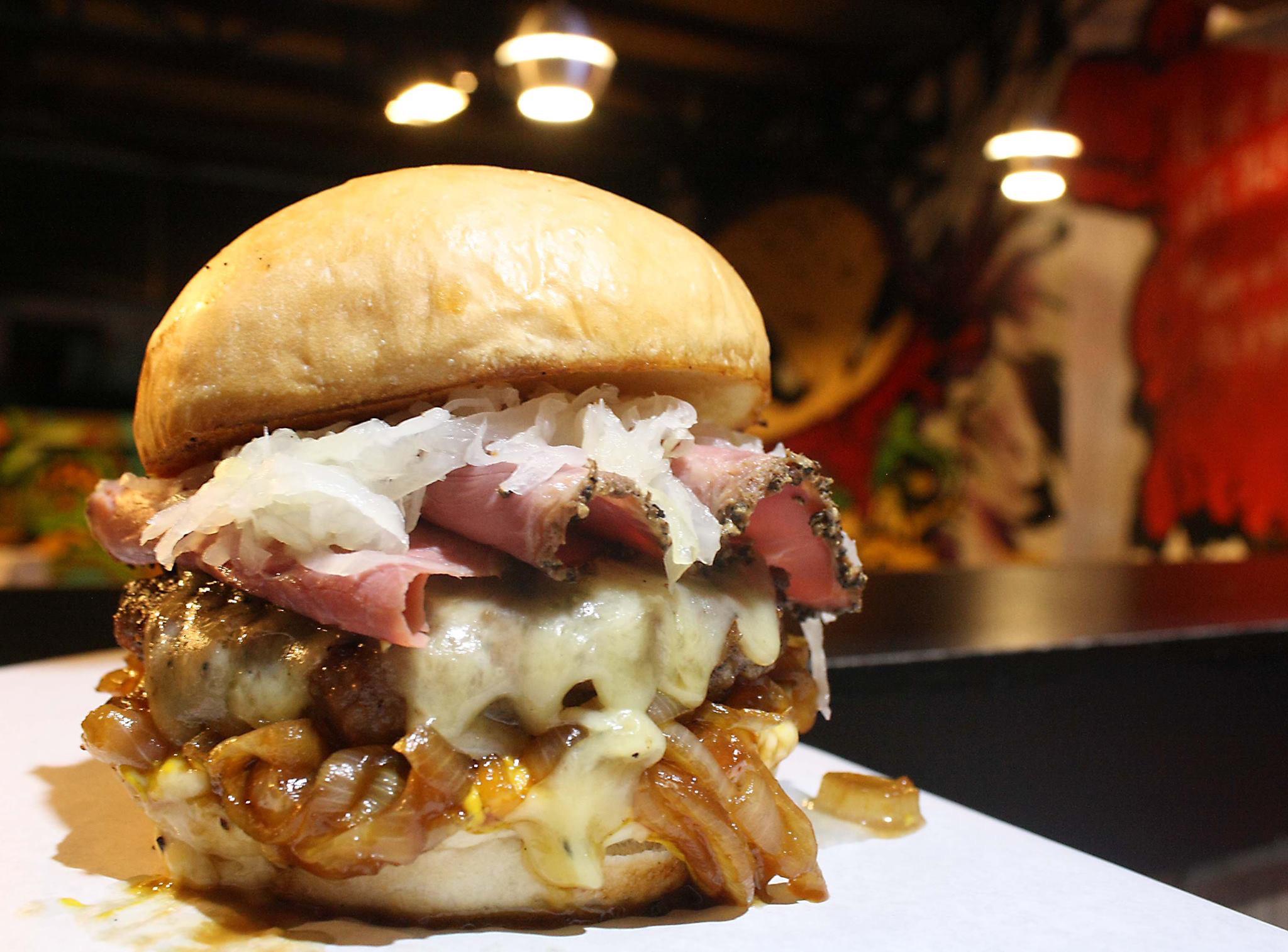 Swiss cheese, pastrami, beef braised onions, sauerkraut + dijon mayo on a 1/3 pounder | Scrolller