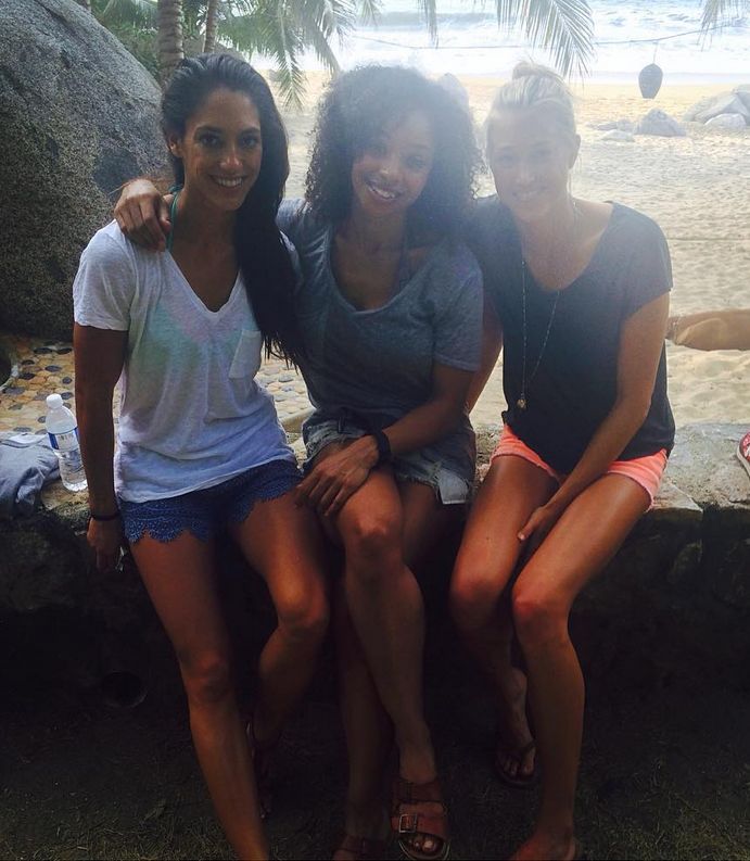 Three athletic models smiling on a beach... | Scrolller