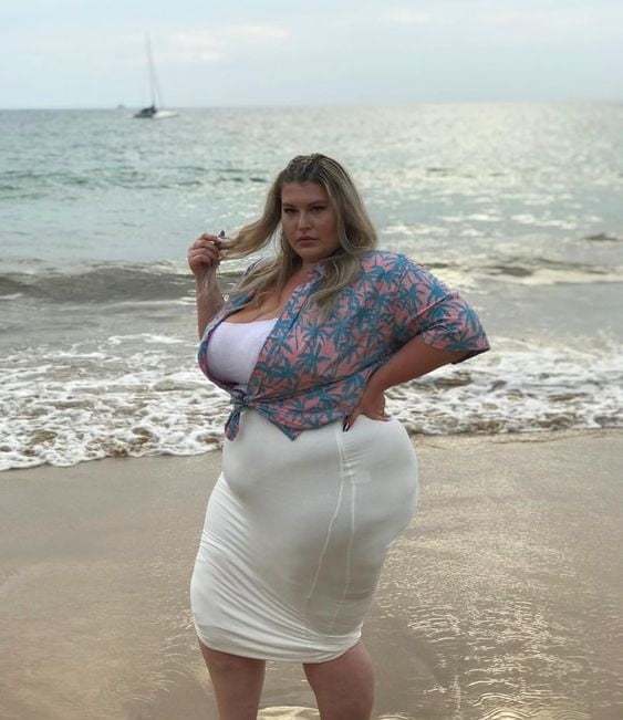 Tight skirt in front of the ocean waves | Scrolller